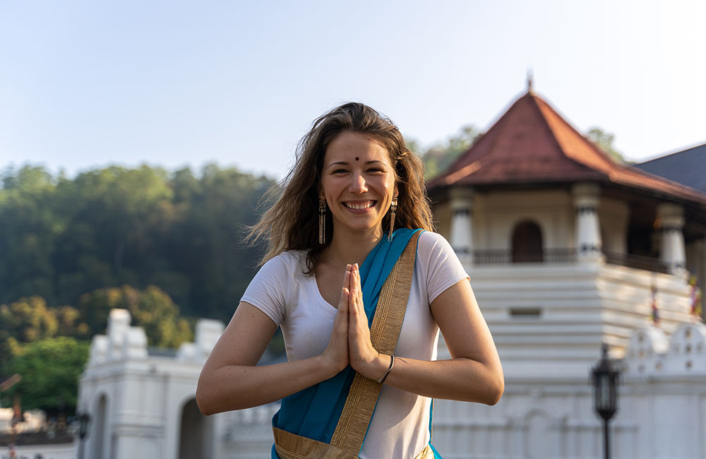 young woman saying Ayubowan | Sri Lanka Travel Guide